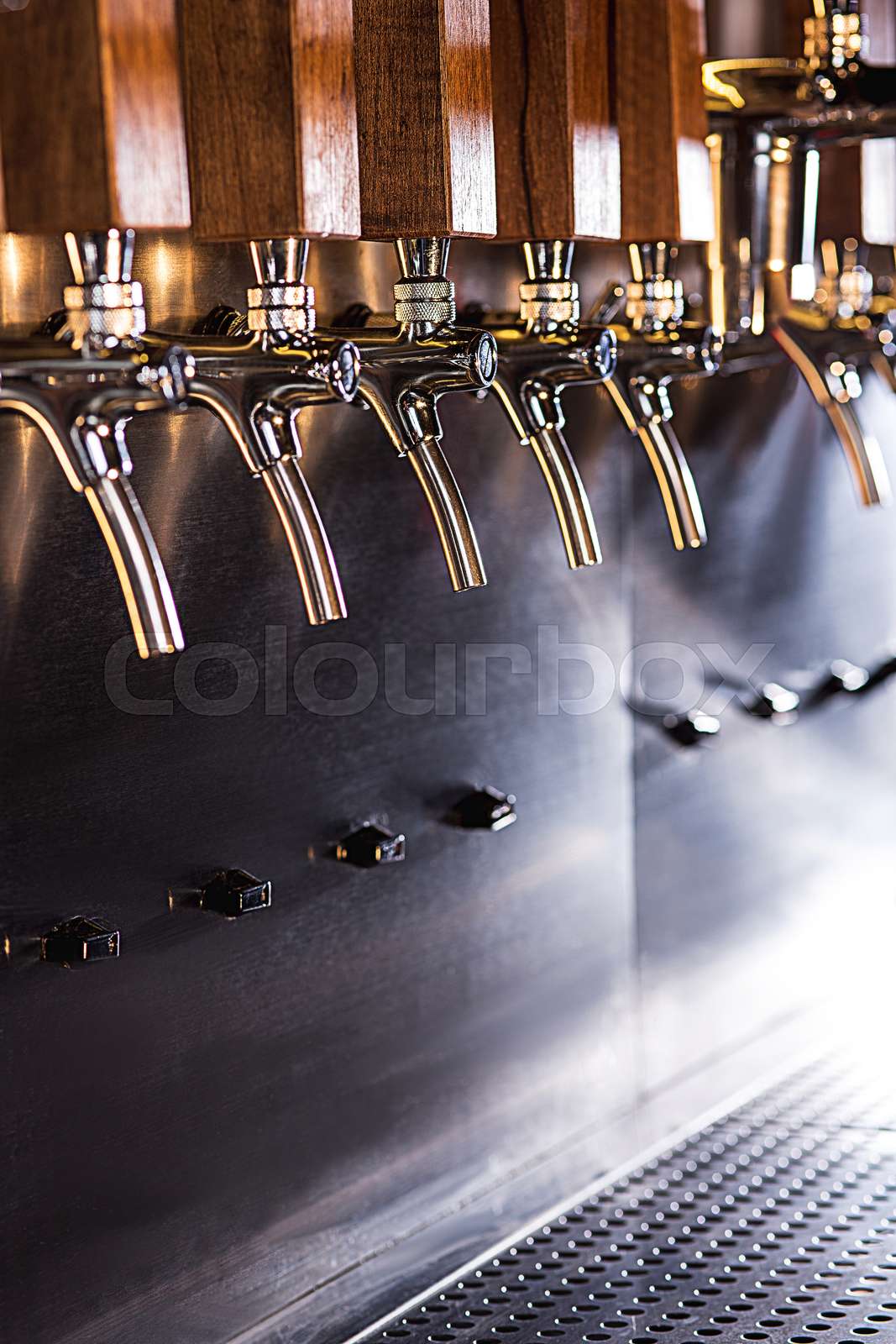 Beer taps in a pub | Stock image | Colourbox