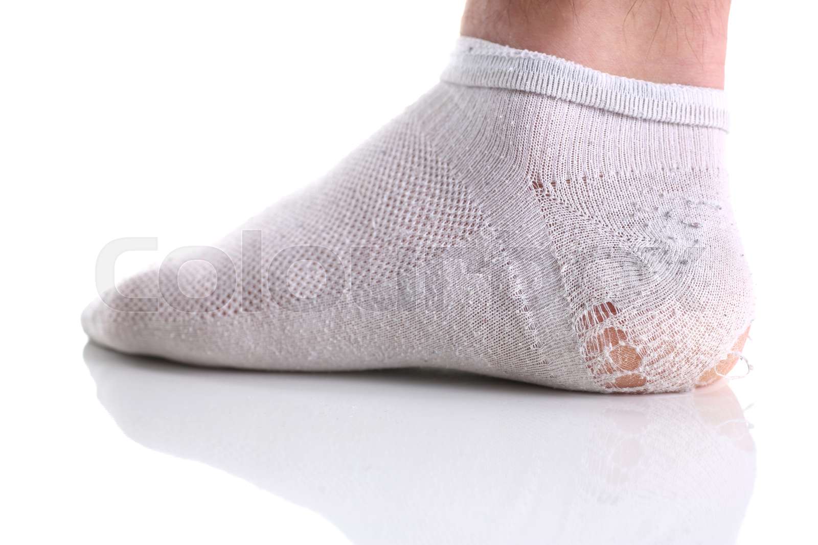 Ripped white sock on male leg isolated | Stock image | Colourbox