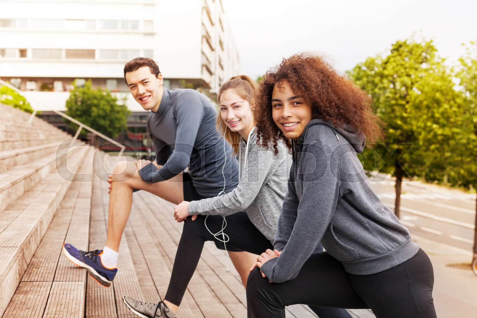 Young people exercising together on city stairs | Stock image | Colourbox