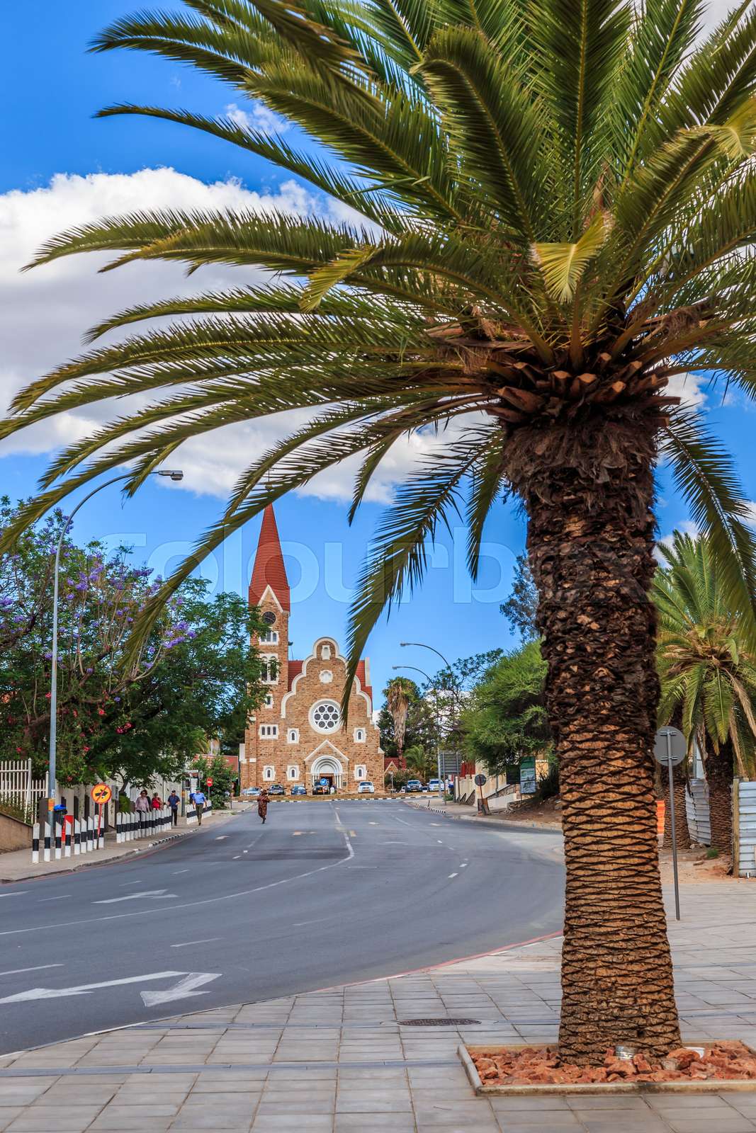 Palm trees along the road and Luteran Christ Church in the end, central ...
