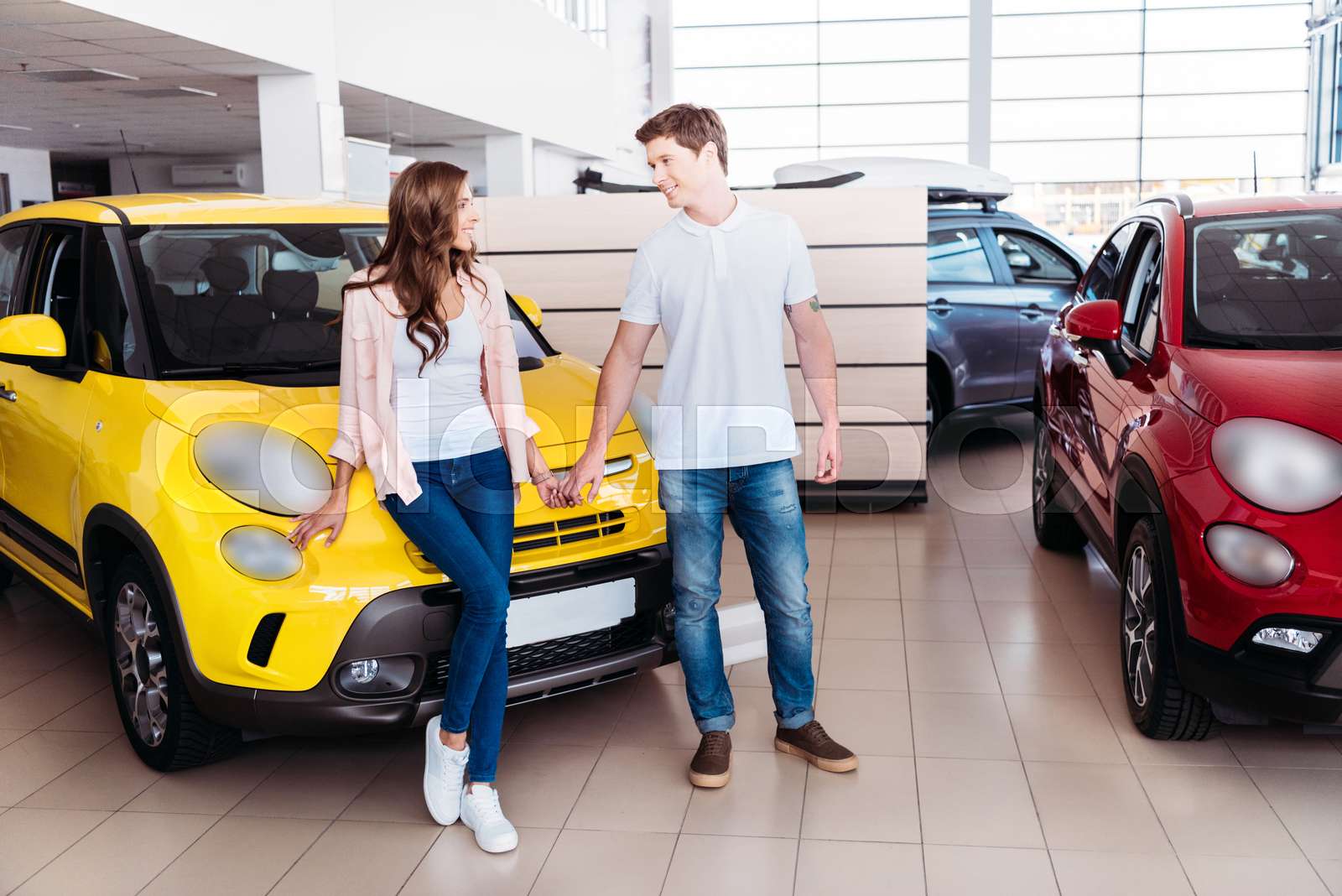 couple holding hands in front of car | Stock image | Colourbox