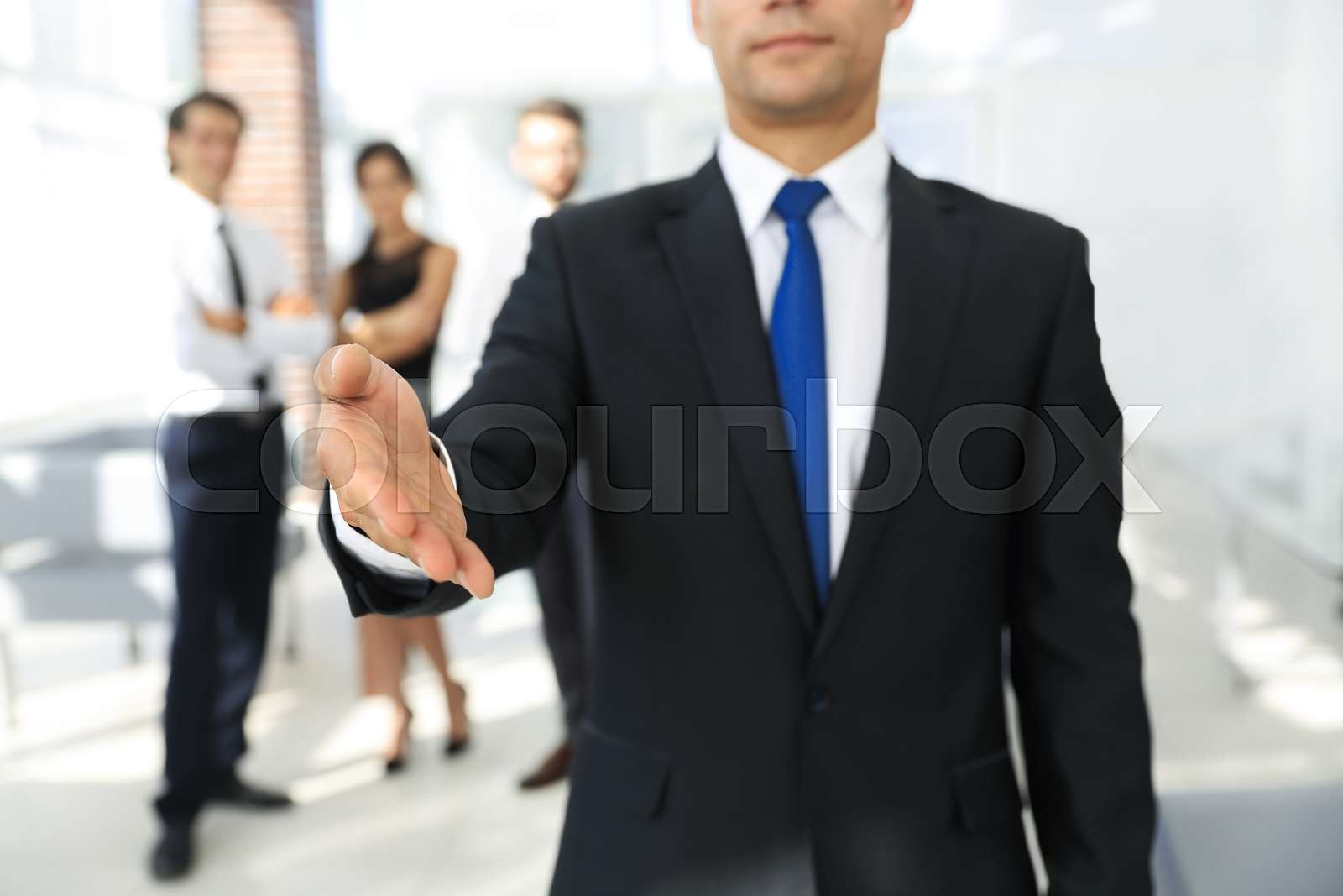 successful businessman giving a hand | Stock image | Colourbox