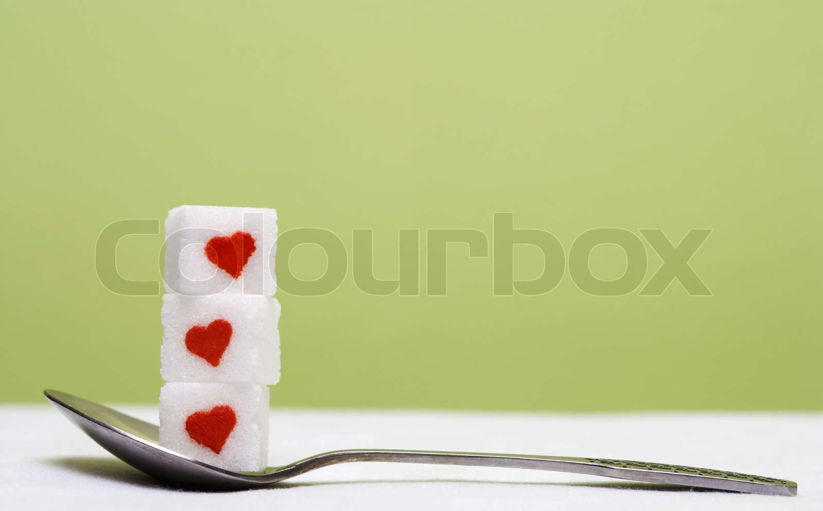 Heart-shaped sugar cubes on spoon | Stock image | Colourbox