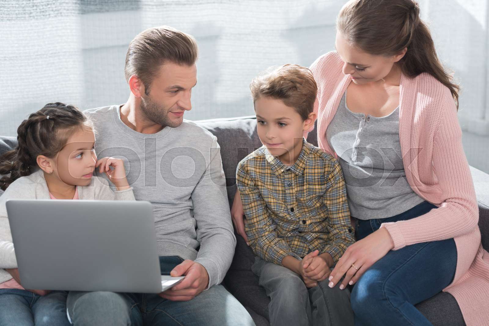 Family sitting on sofa | Stock image | Colourbox