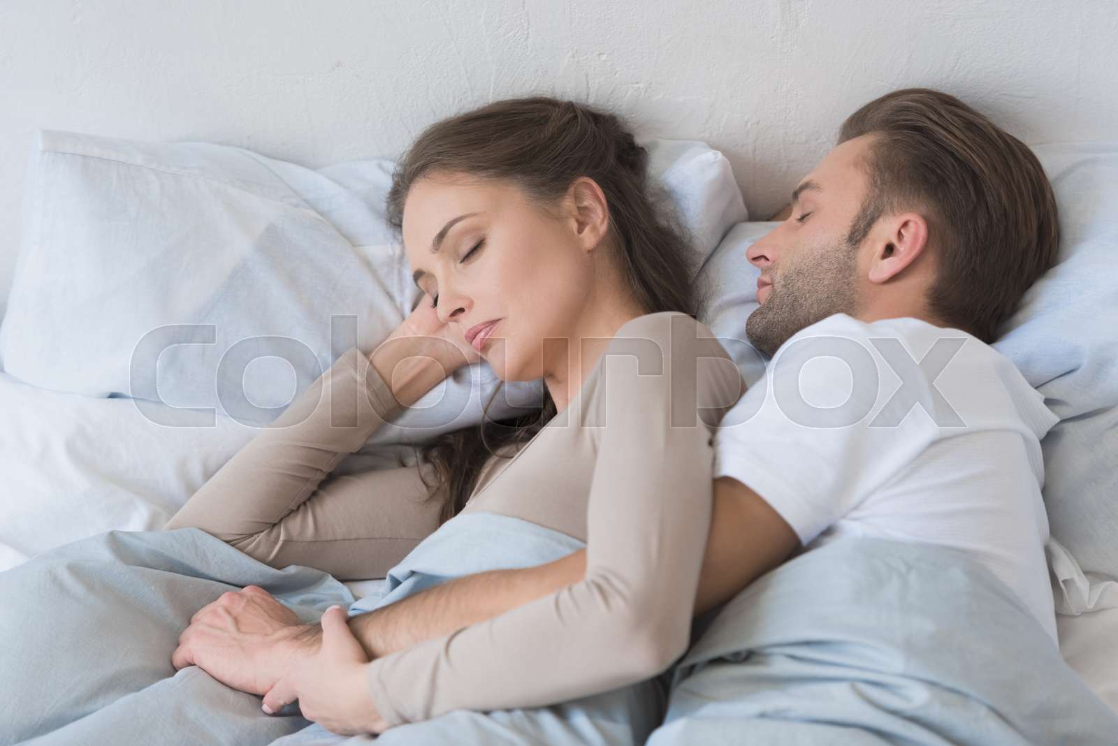 Boyfriend hugging girlfriend in bed | Stock image | Colourbox