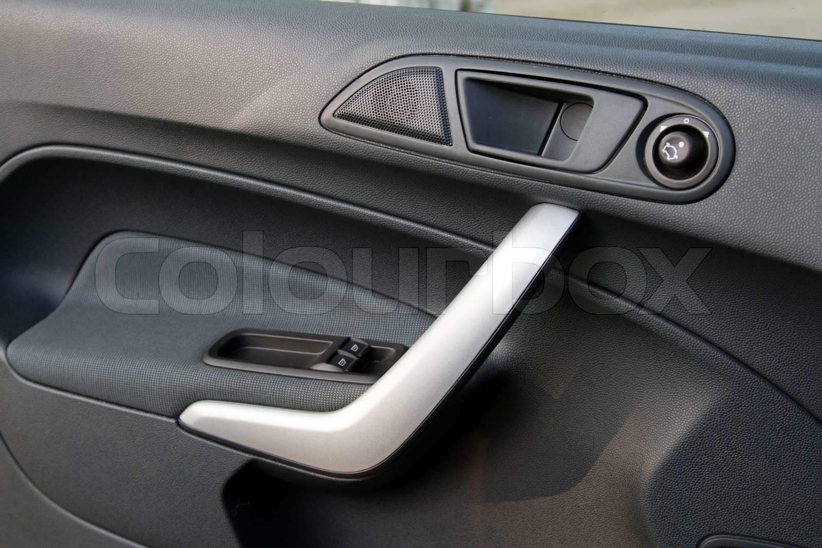 Door control knobs in a modern car | Stock image | Colourbox