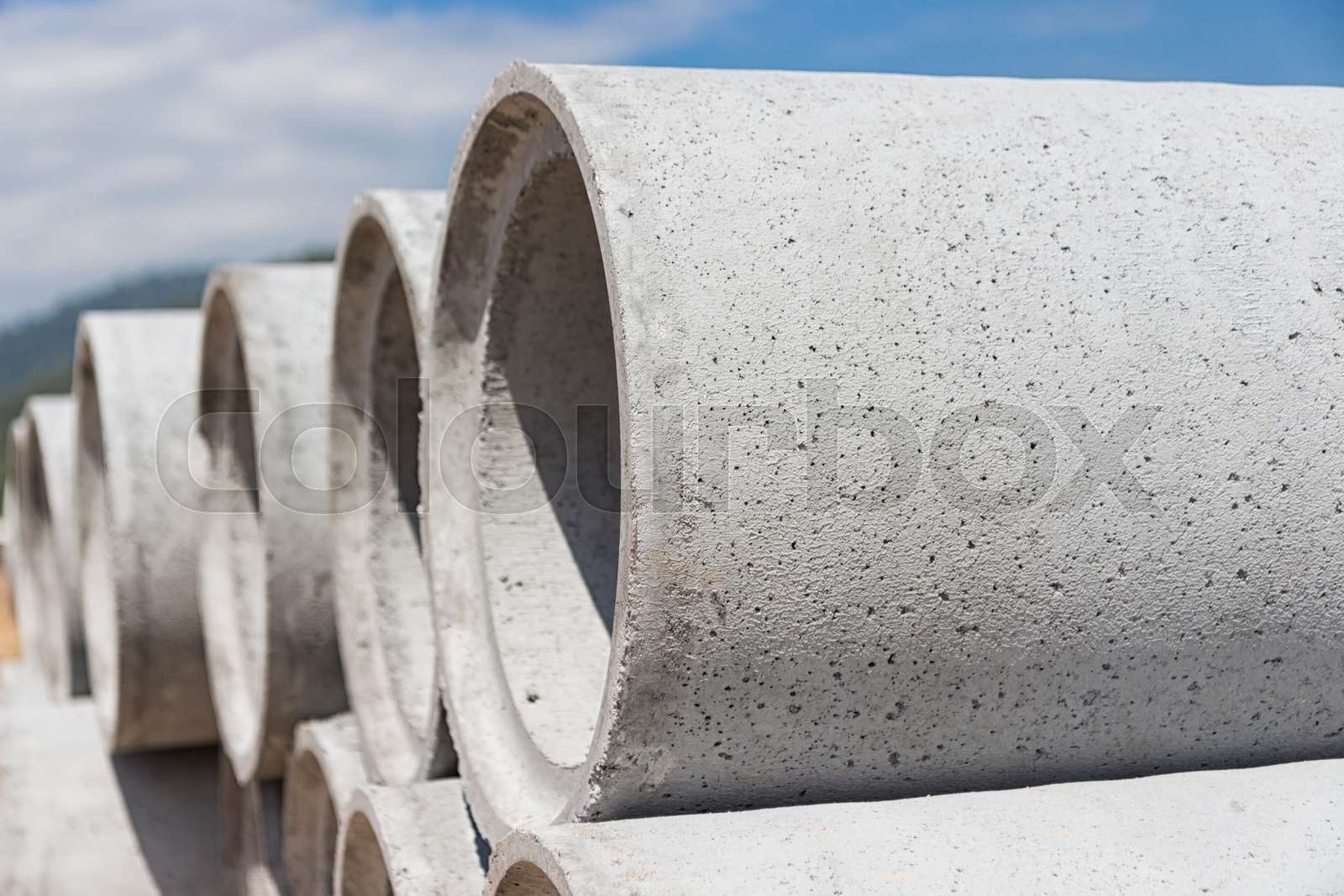 Precast concrete manholes are stored on the ground ready for ...
