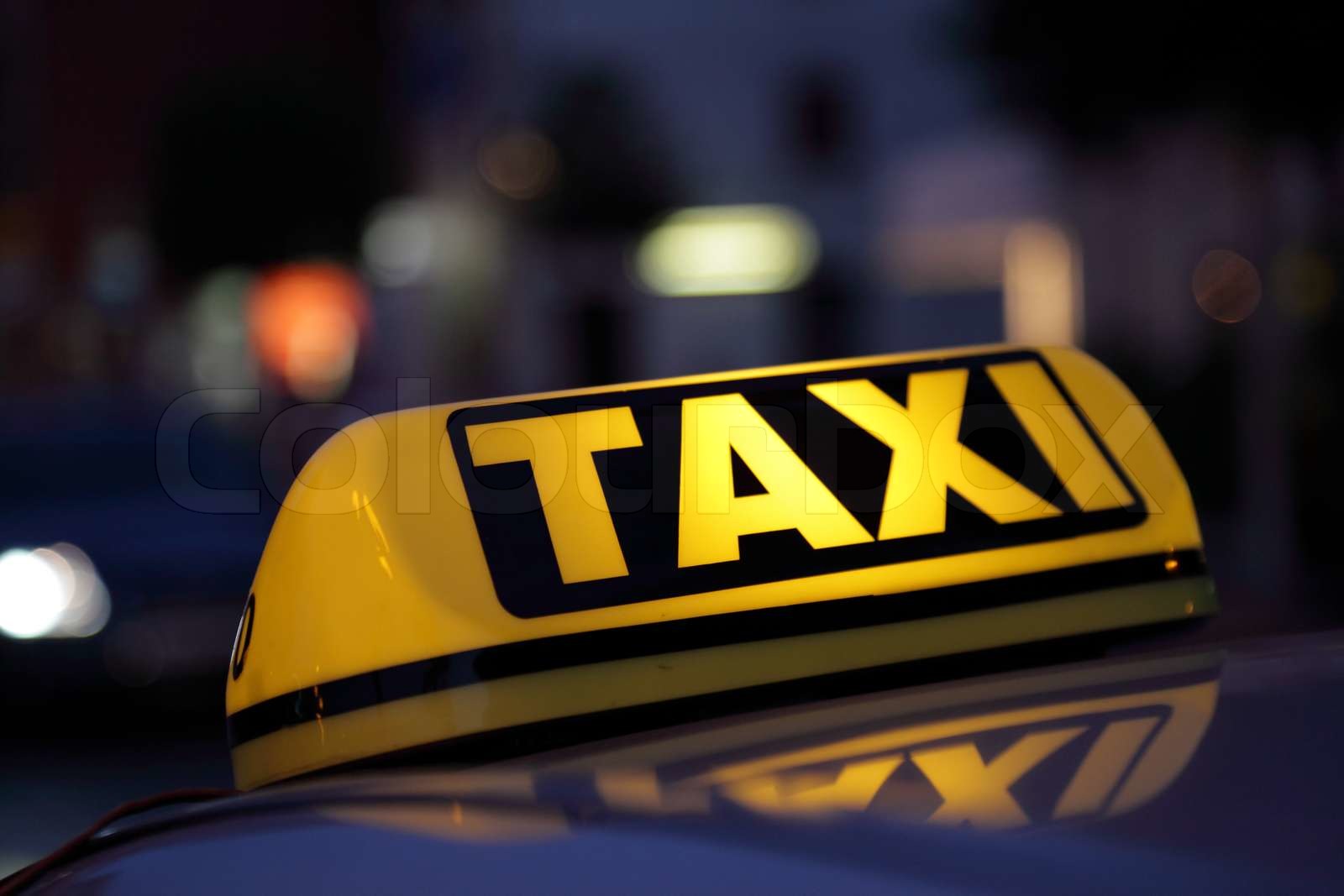 Taxi sign illuminated at night | Stock image | Colourbox