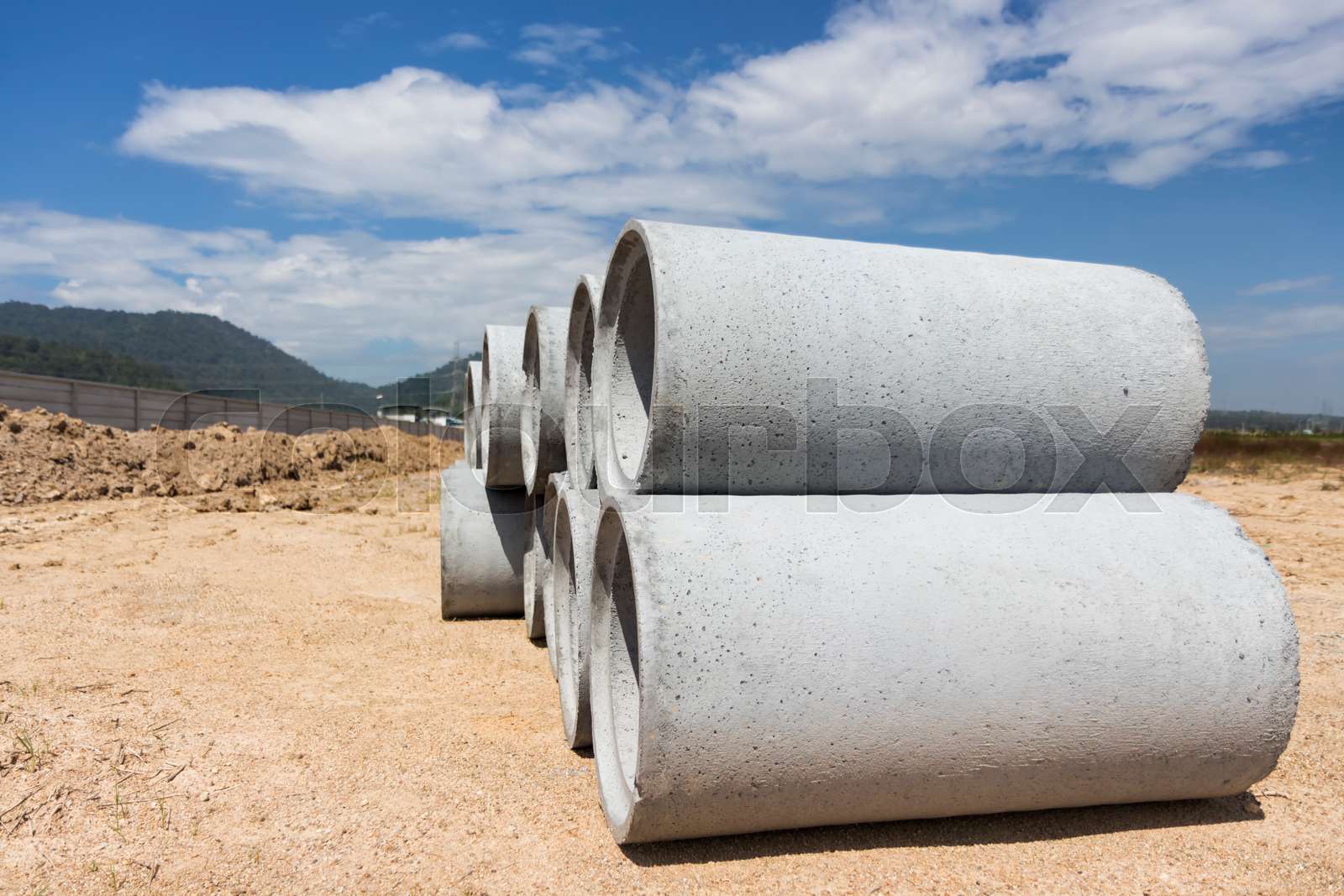 Precast concrete manholes are stored on the ground ready for ...