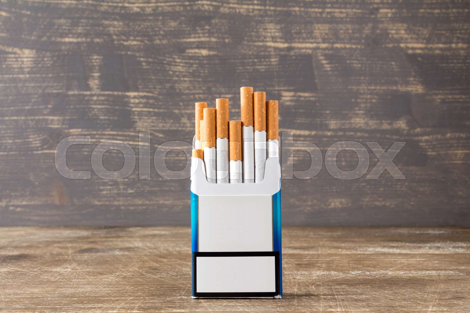 Open pack of cigarettes stands vertically | Stock image | Colourbox