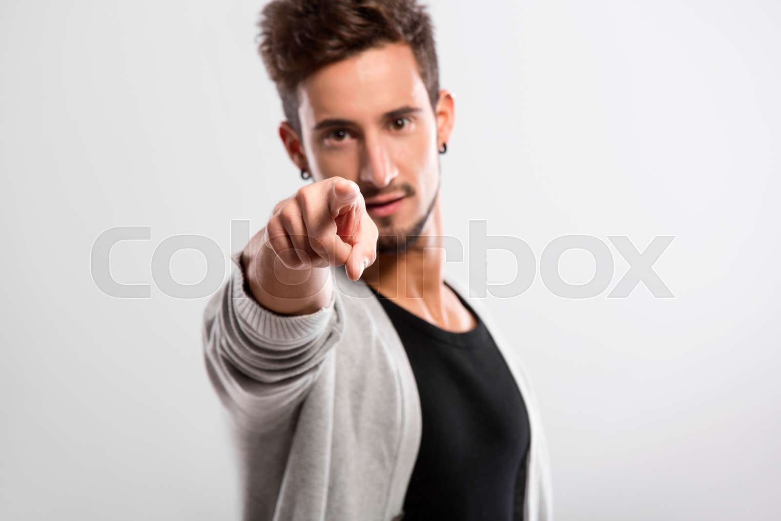 Young man pointing | Stock image | Colourbox