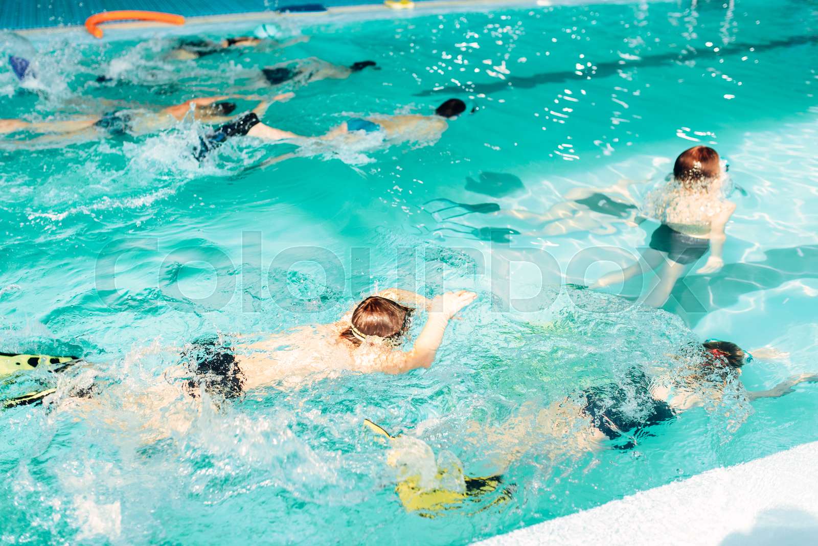 Children swimming underwater in pool | Stock image | Colourbox