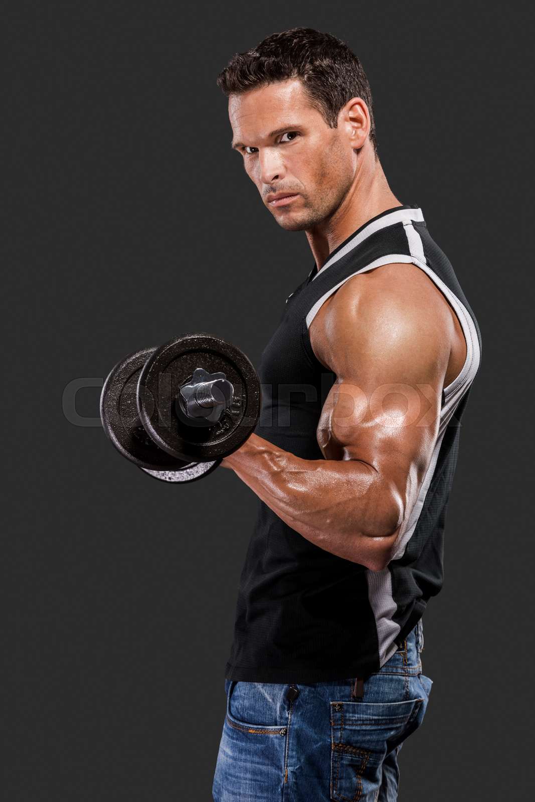 Muscle man lifting weights | Stock image | Colourbox