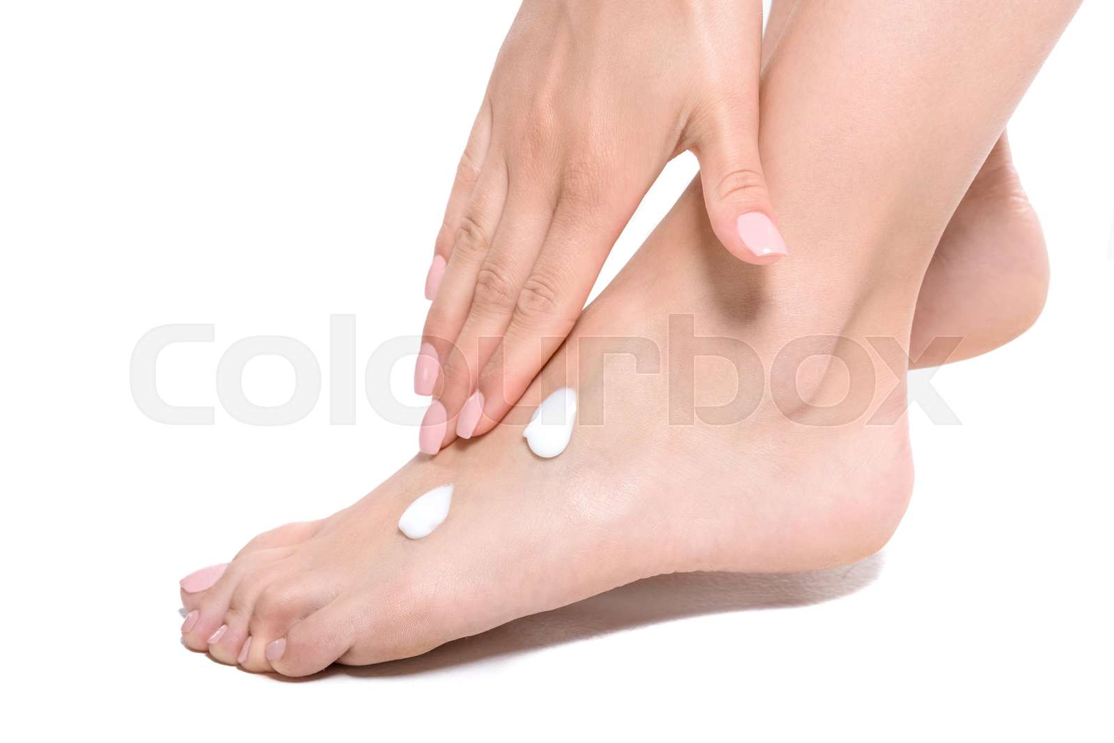 Woman Applying Cream To Legs | Stock image | Colourbox
