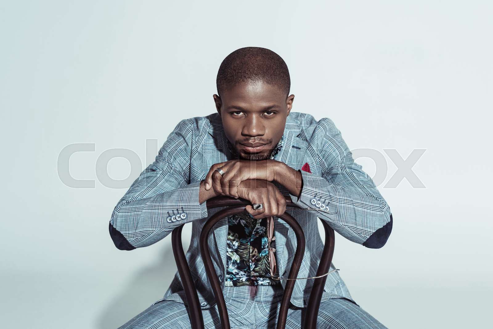 Stylish man sitting on chair backwards | Stock image | Colourbox