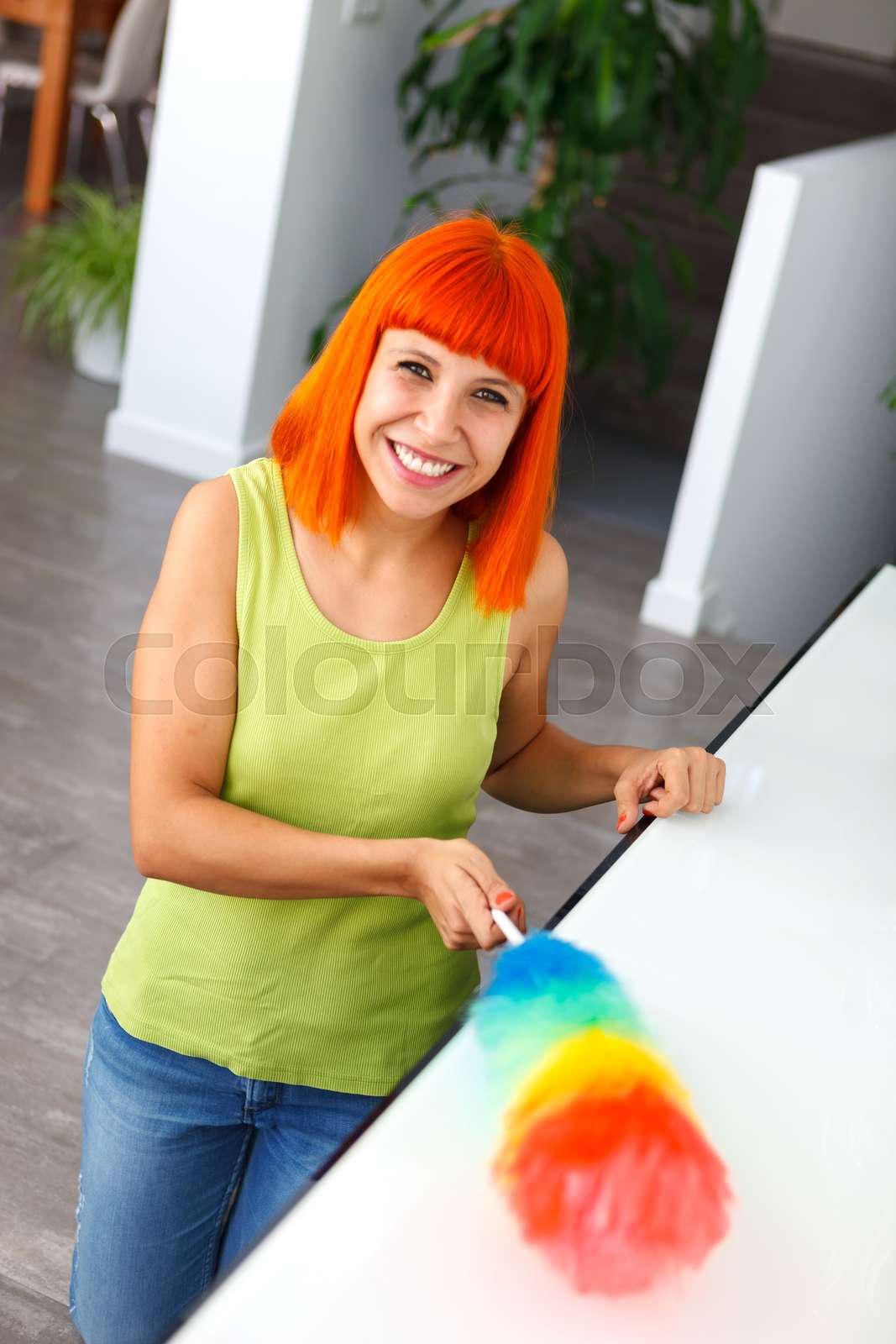Red hair housewife cleaning her home | Stock image | Colourbox