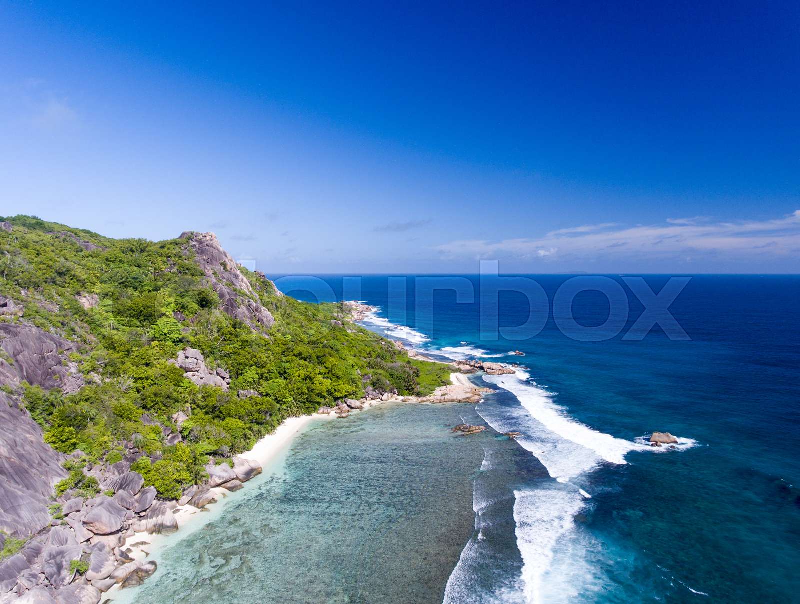 Aerial view of coral reef with mountains, rocks and vegetation | Stock ...
