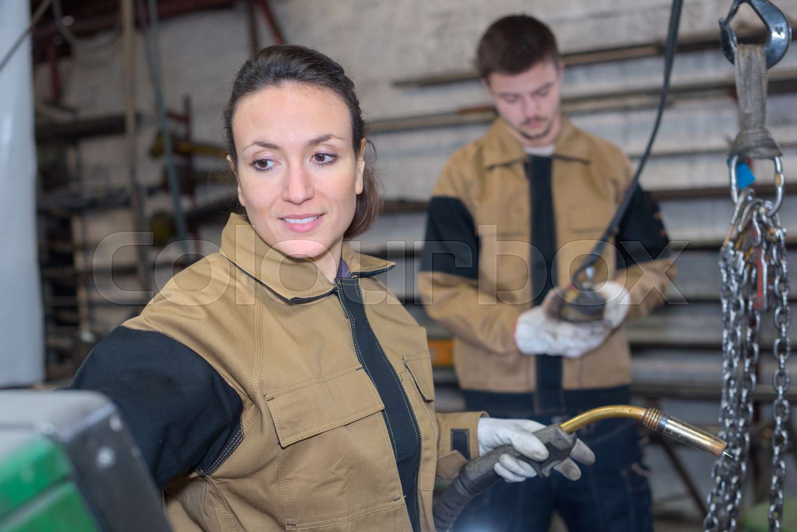adult industrial female worker spot welder in factory workshop | Stock ...