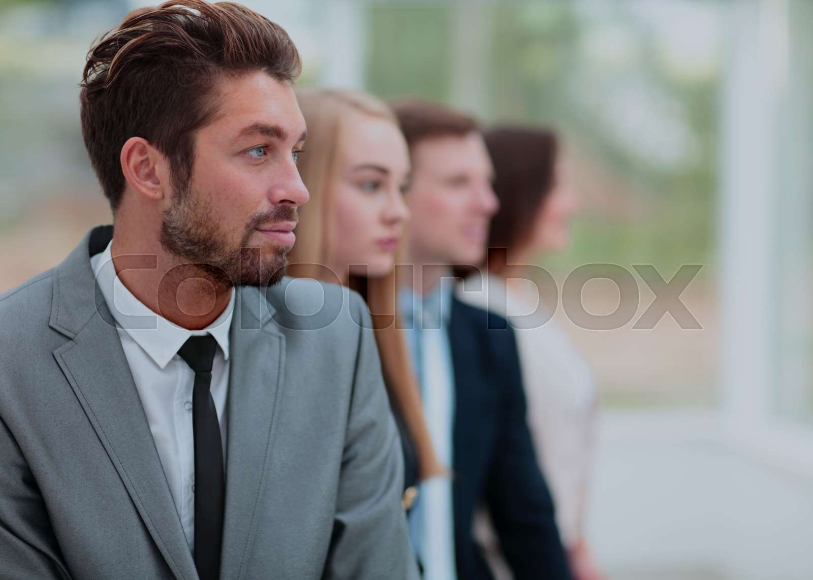 Business people standing in a row looking in same direction | Stock ...