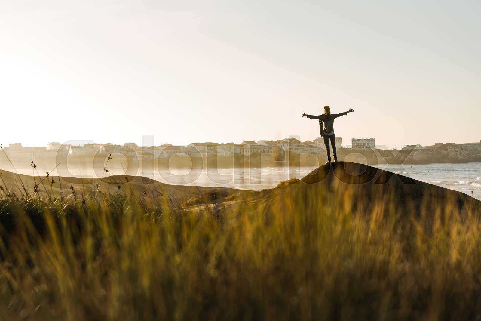 Woman over the cliff | Stock image | Colourbox