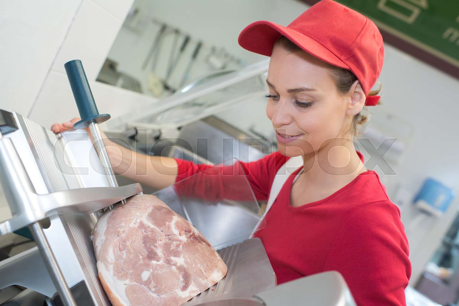 female butcher cutting meat | Stock image | Colourbox