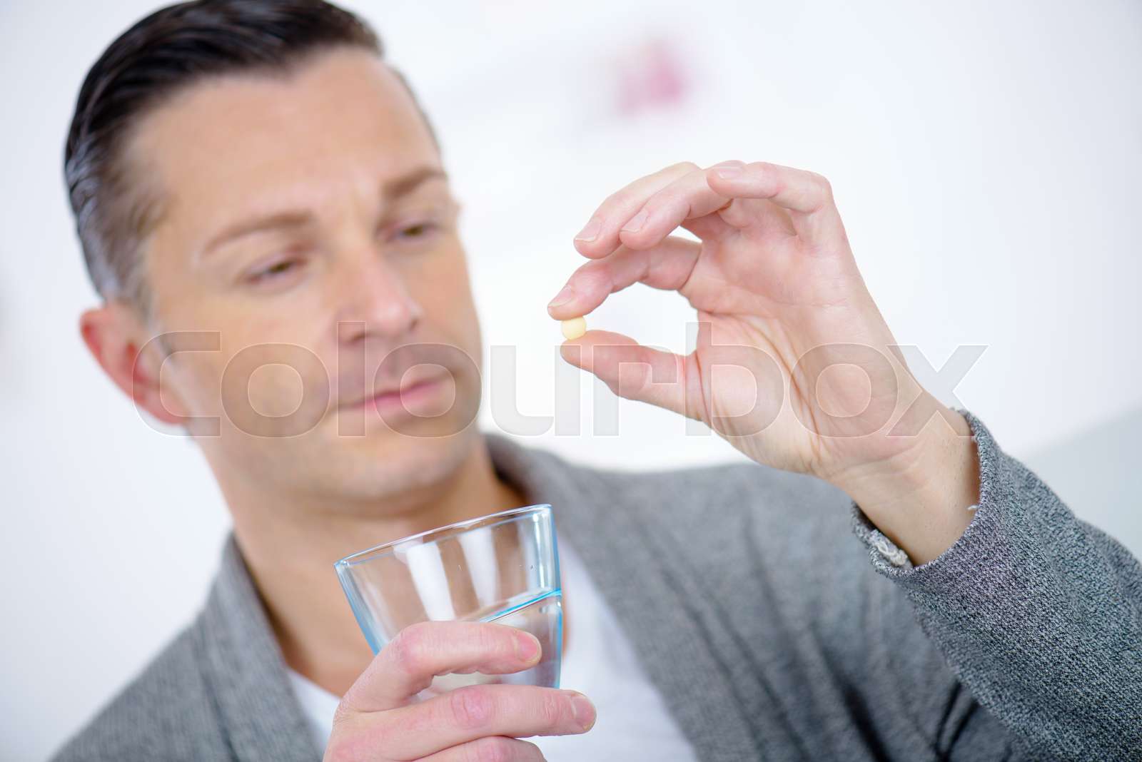 man taking his vitamins | Stock image | Colourbox