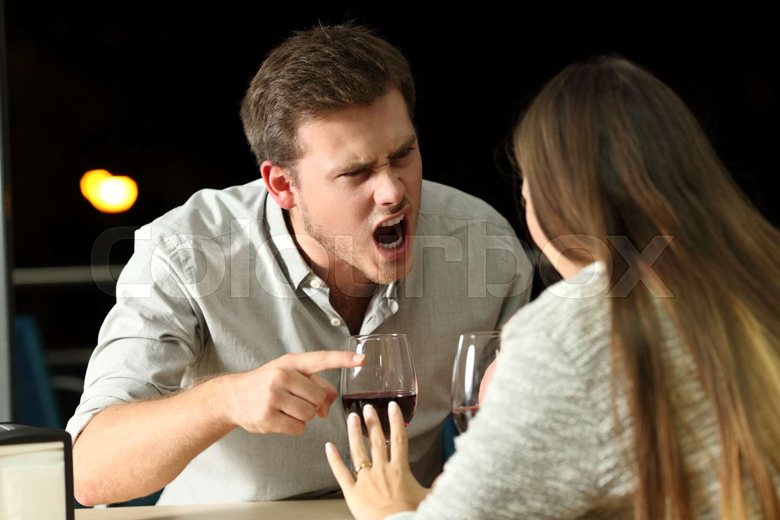Angry couple arguing in a bar at night | Stock image | Colourbox