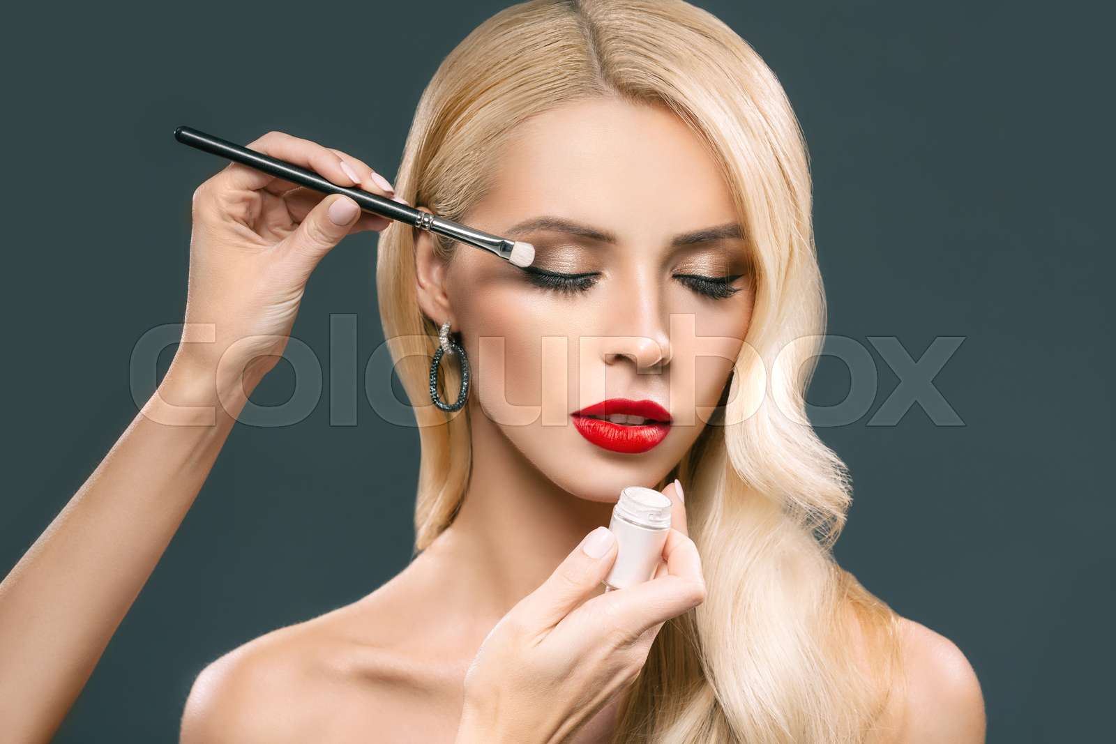 woman applying makeup | Stock image | Colourbox