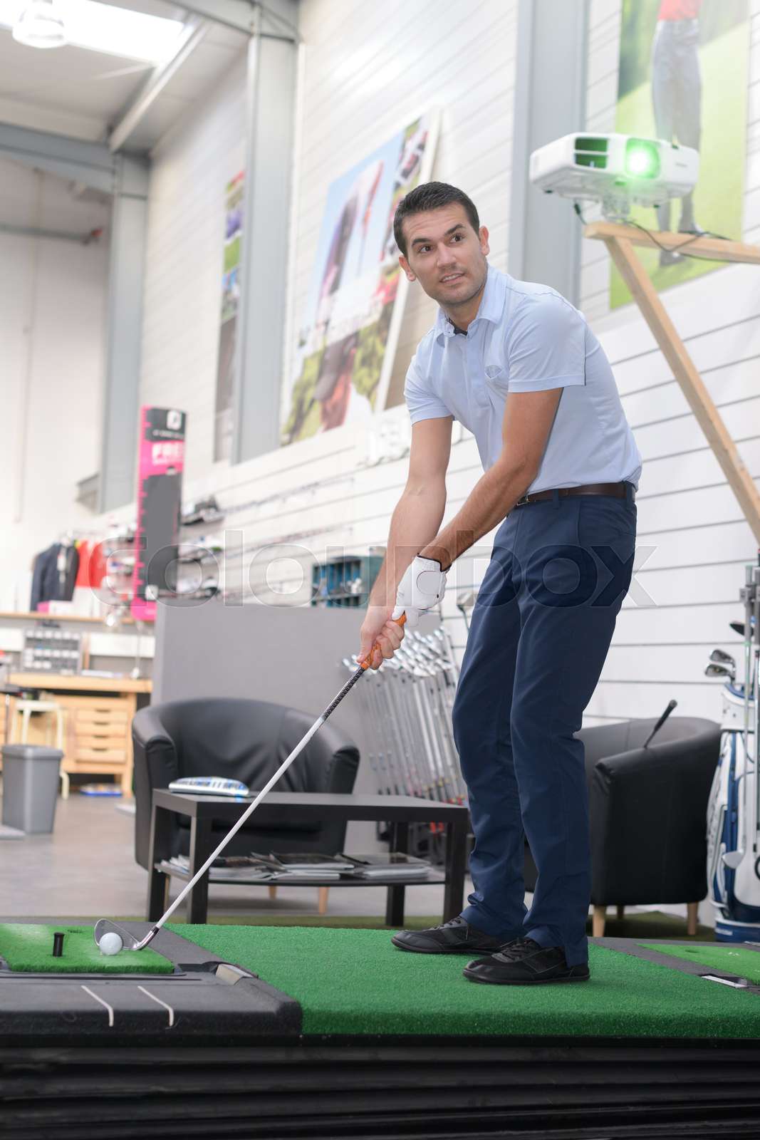 playing golf inside while having fun | Stock image | Colourbox