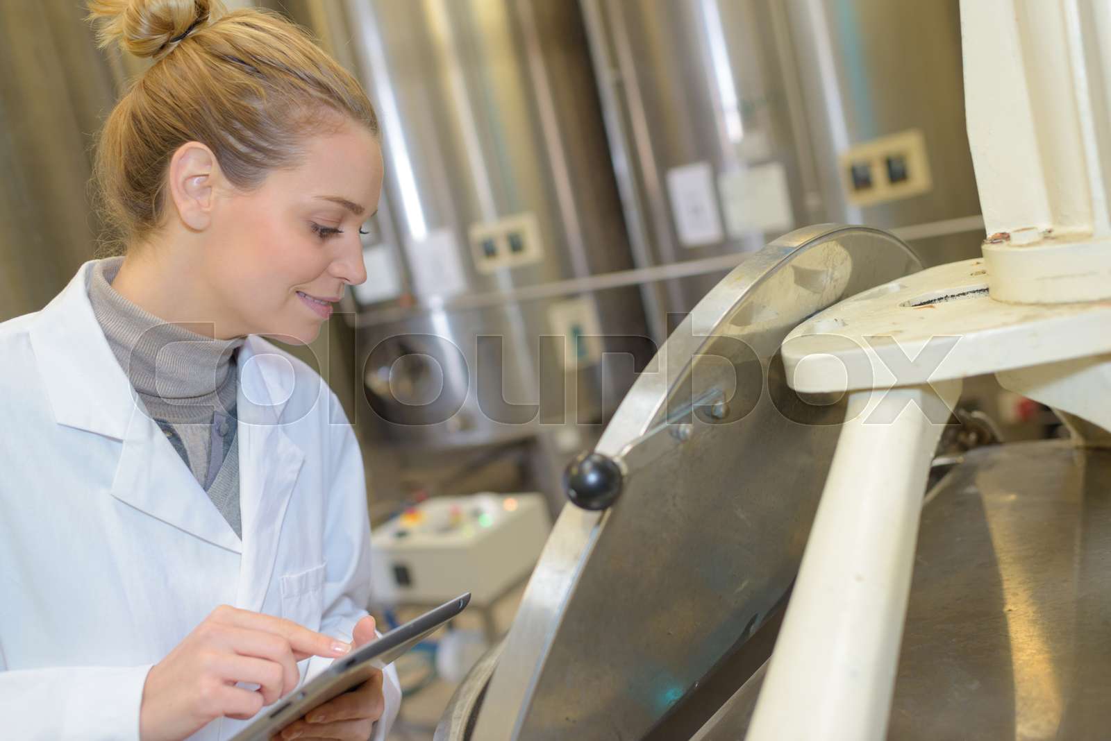 checking the inside of a vat in a factory | Stock image | Colourbox