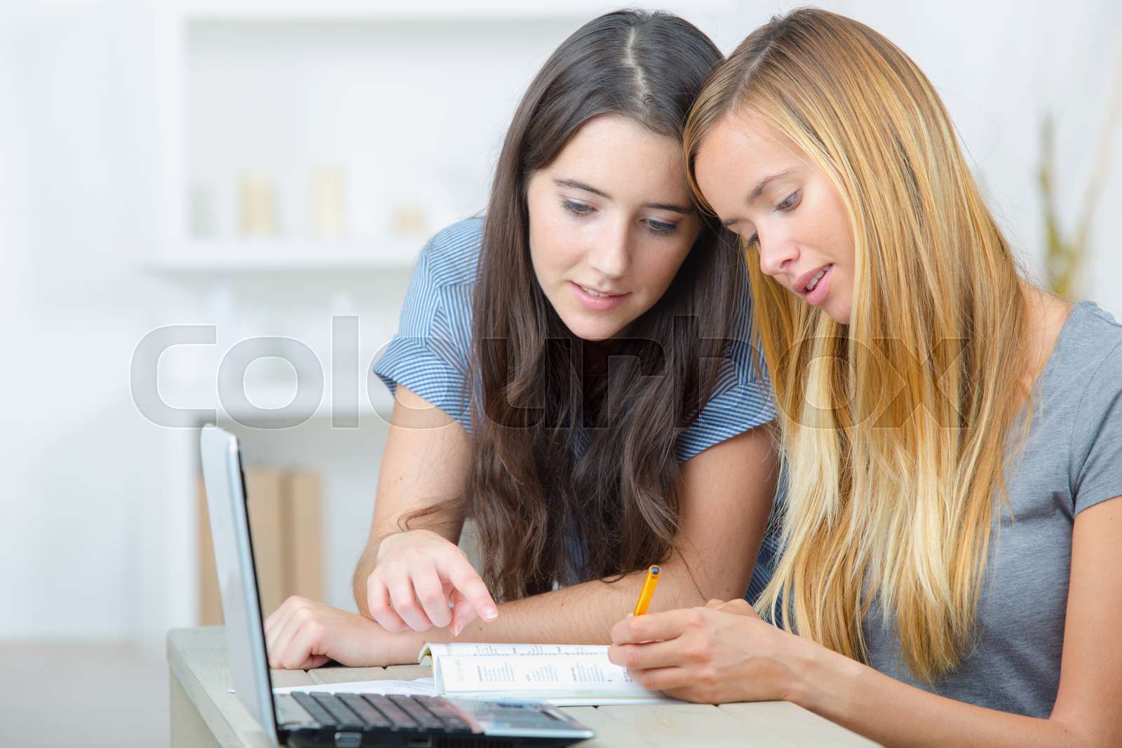 Two teenage girls studying | Stock image | Colourbox