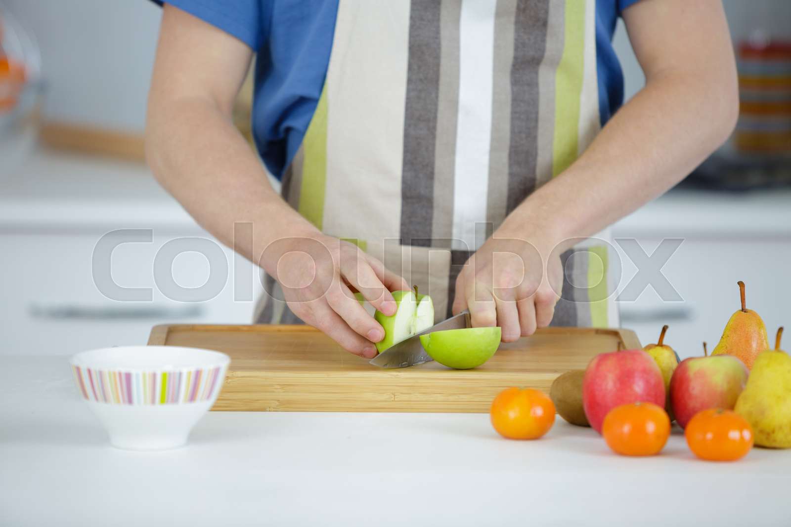 cutting apples into quarters | Stock image | Colourbox