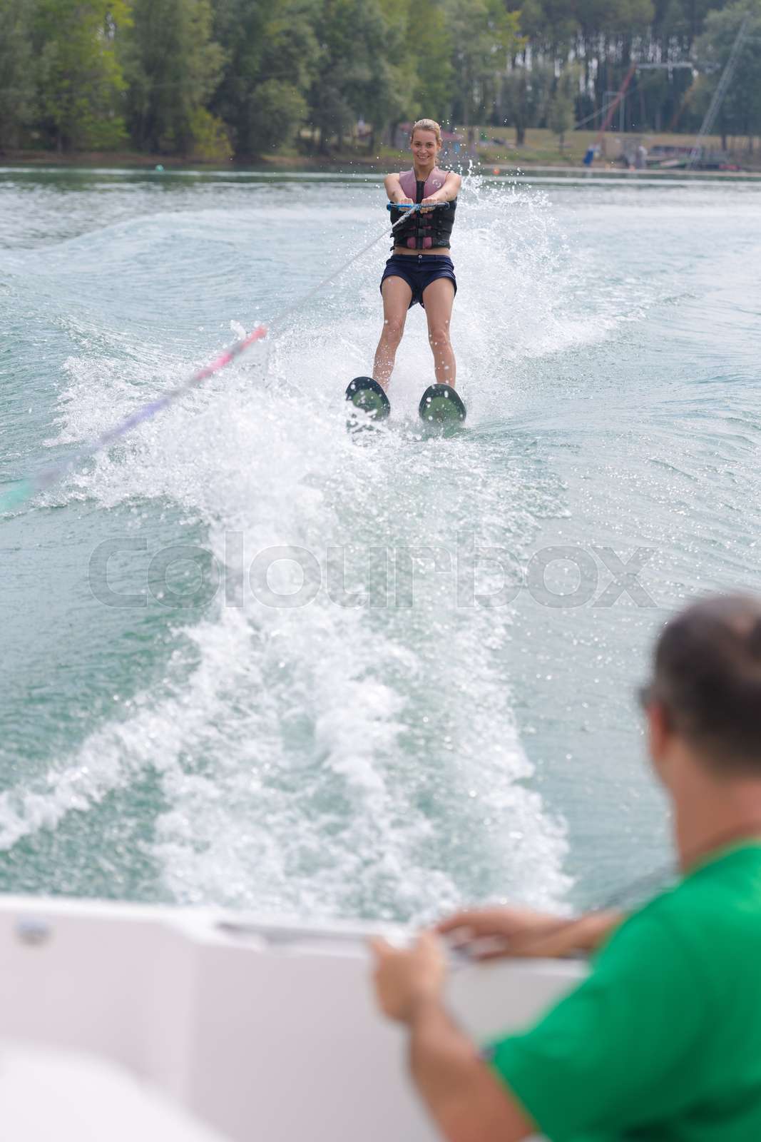 young pretty woman riding wakeboard on wave | Stock image | Colourbox