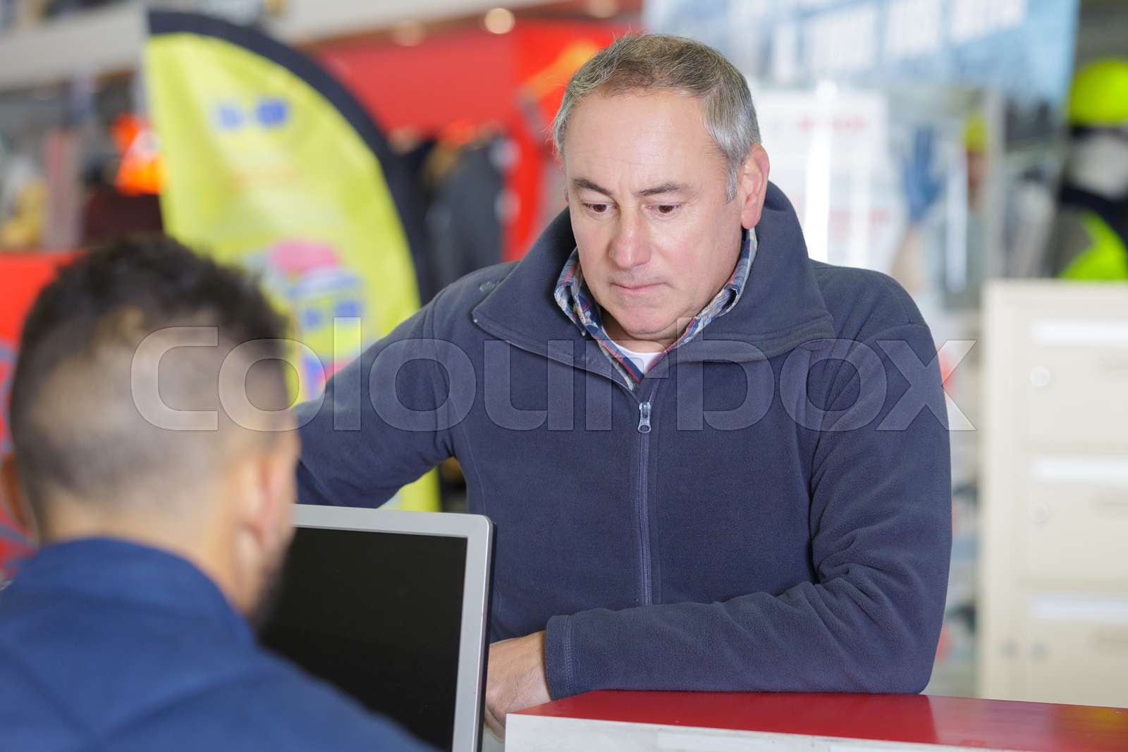 salesman and client at cash counter in hardware store | Stock image ...