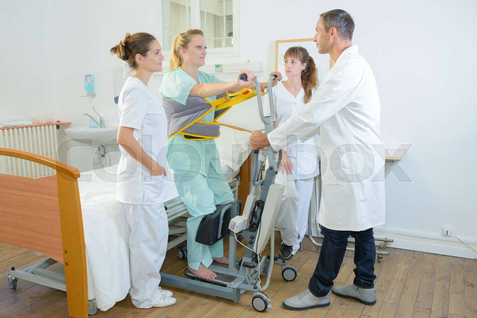 patient standing in a medical room with doctors | Stock image | Colourbox