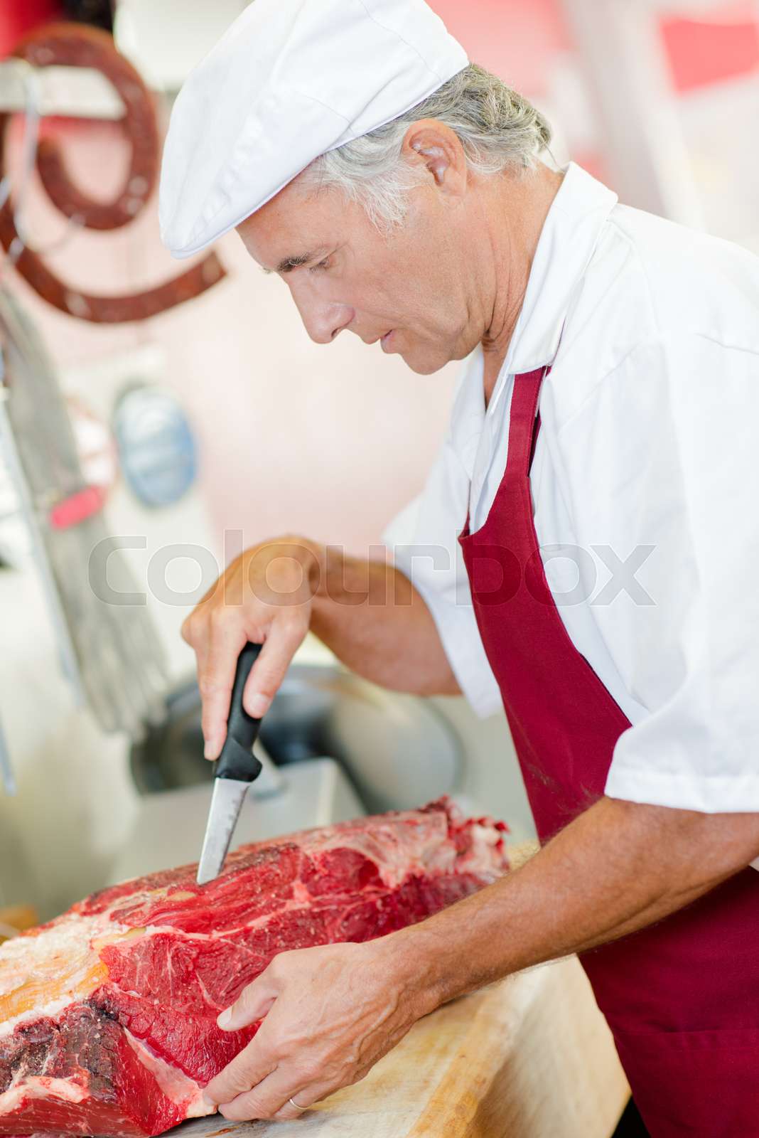 Butcher cutting up meat | Stock image | Colourbox