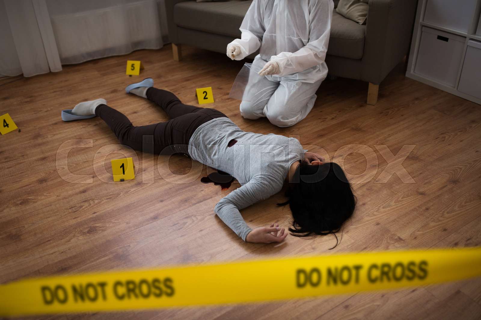 criminalist collecting evidence at crime scene | Stock image | Colourbox
