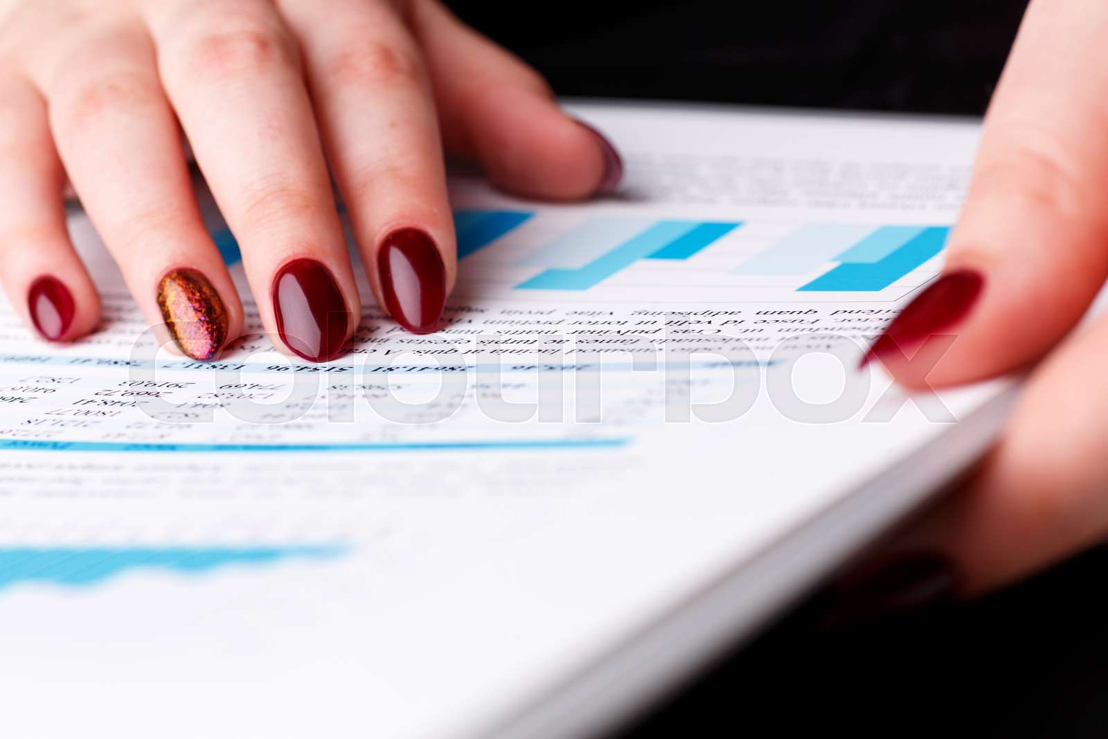 Female arm point finger in financial graph | Stock image | Colourbox