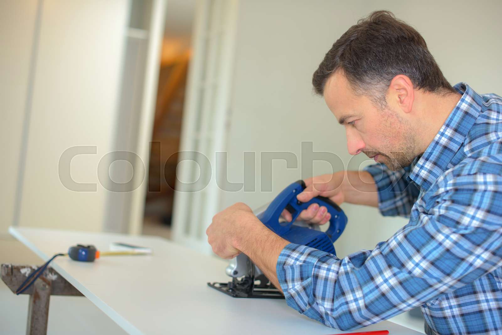 Carpenter using a band saw | Stock image | Colourbox