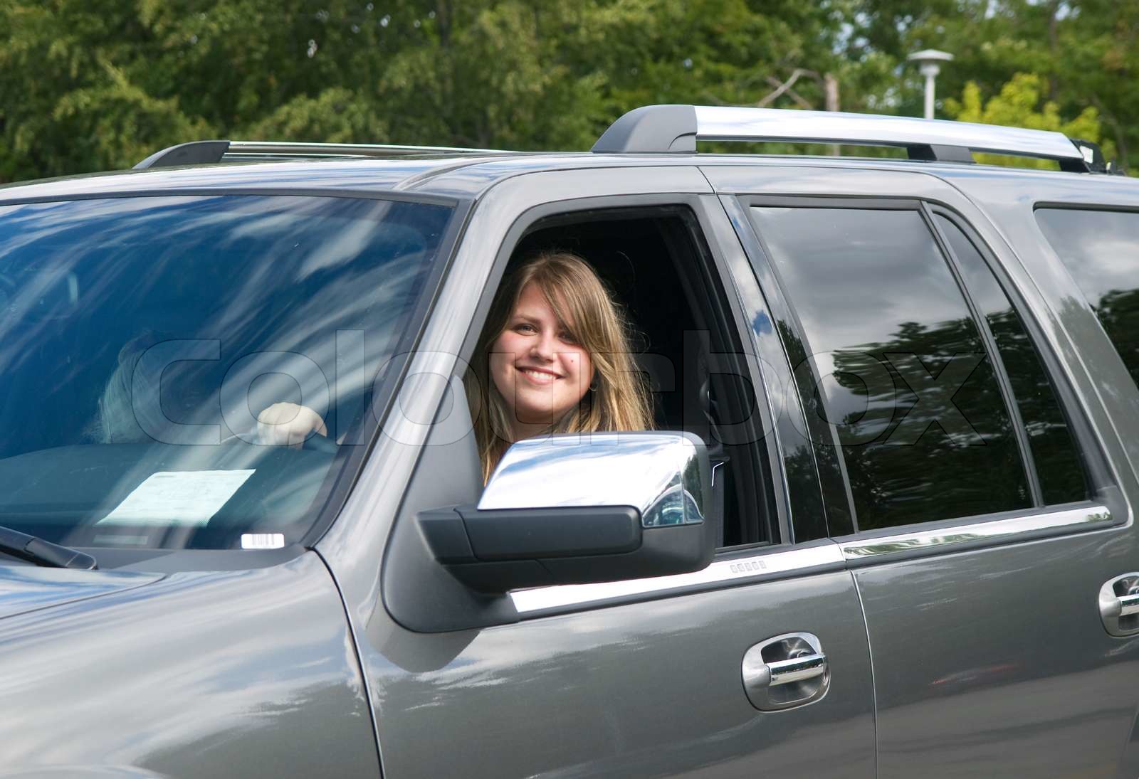 Young smiling lady drive the car | Stock image | Colourbox