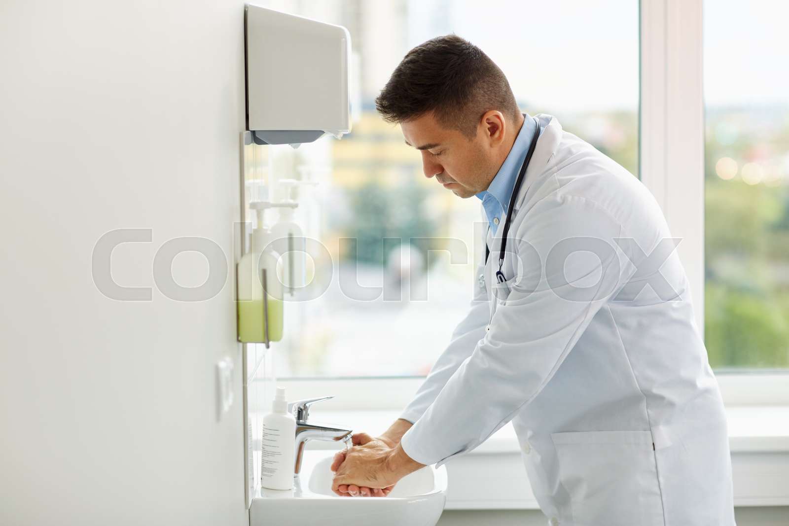 doctor washing hands at medical clinic sink | Stock image | Colourbox