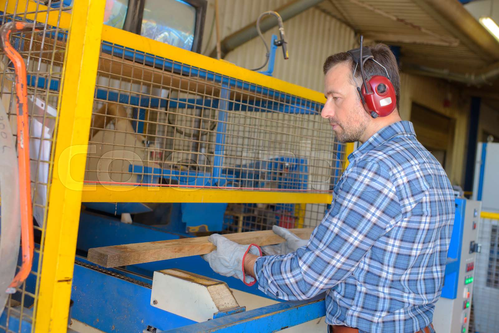 sawmill employee working with wood tools and machinery | Stock image ...