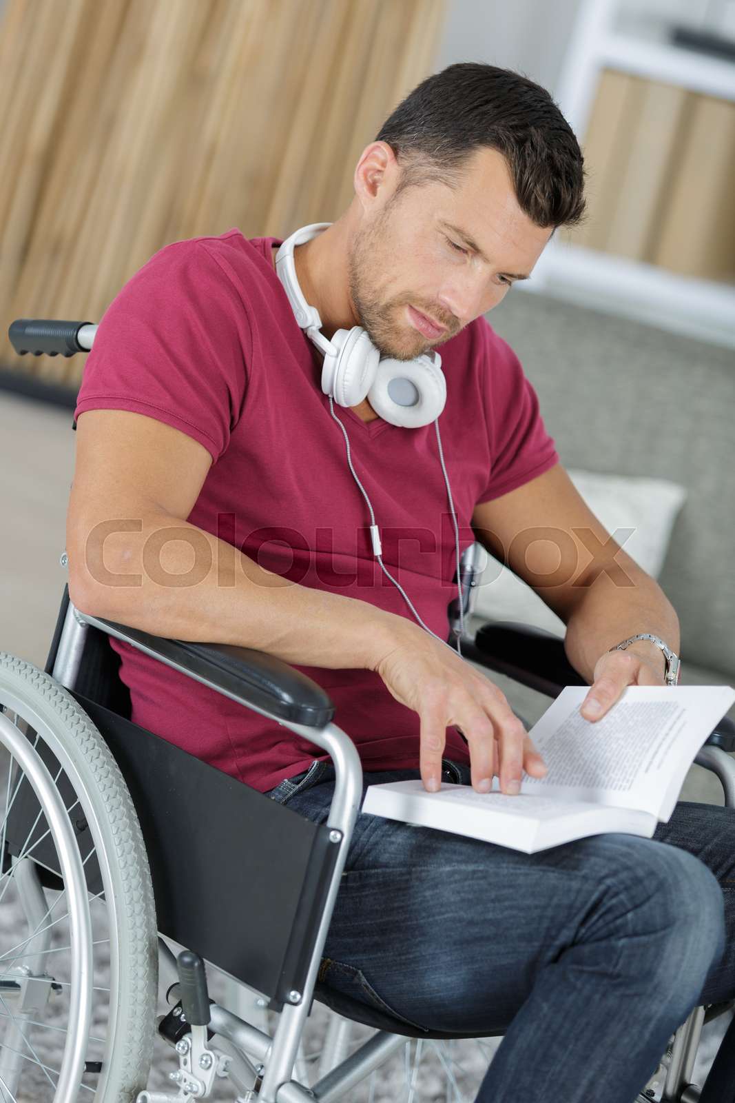 disabled man in wheelchair reading a book | Stock image | Colourbox