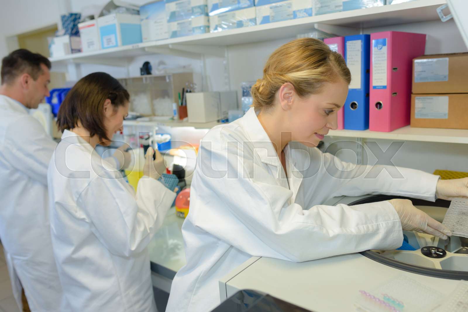 Lab technician using centrifugal machine | Stock image | Colourbox