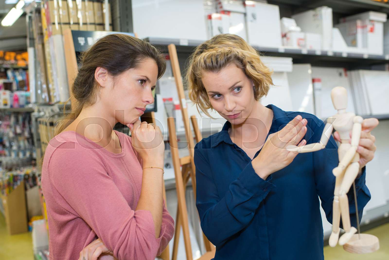 young brunette woman buying drawing model in art department | Stock ...
