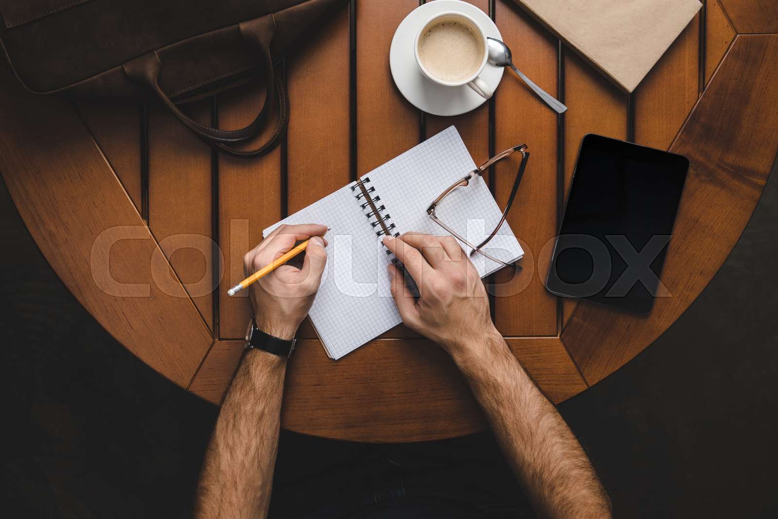 man writing in notepad | Stock image | Colourbox
