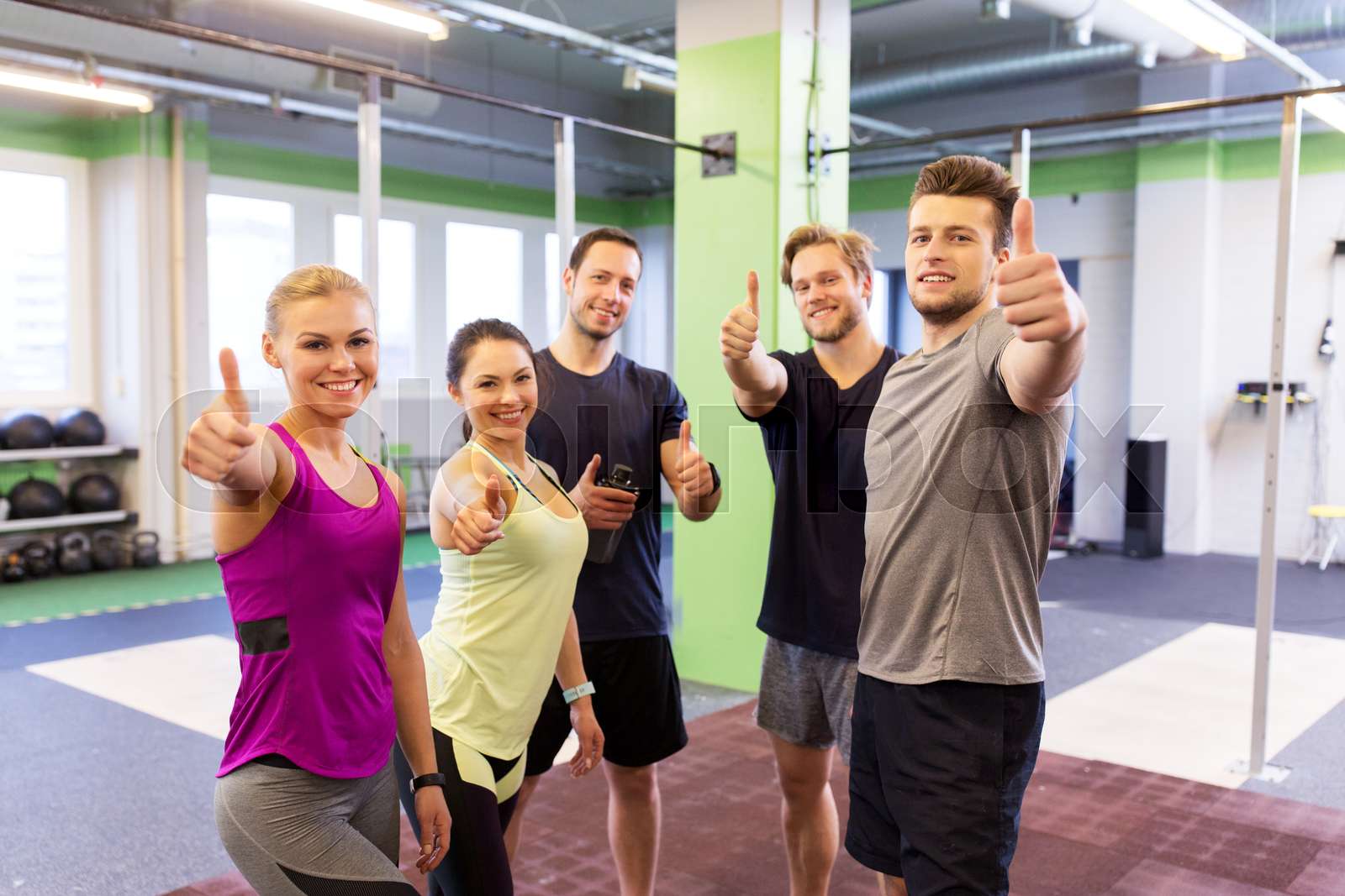 group of happy friends in gym showing thumbs up | Stock image | Colourbox
