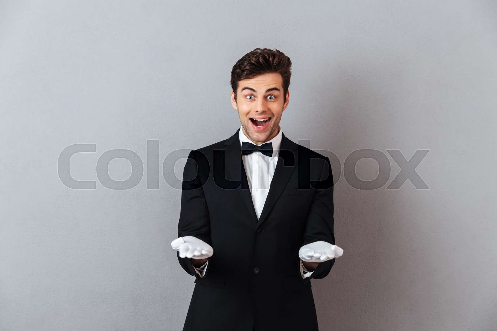 Surprised young waiter standing isolated | Stock image | Colourbox