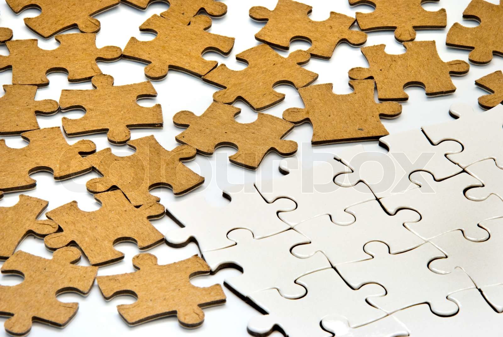 heap of white and brown puzzle pieces | Stock image | Colourbox