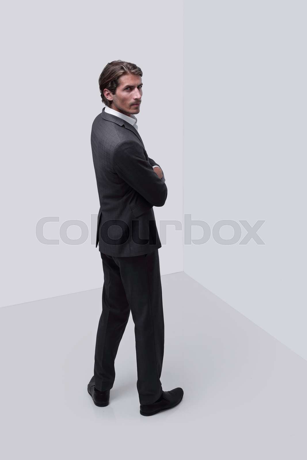 serious businessman standing in corner | Stock image | Colourbox